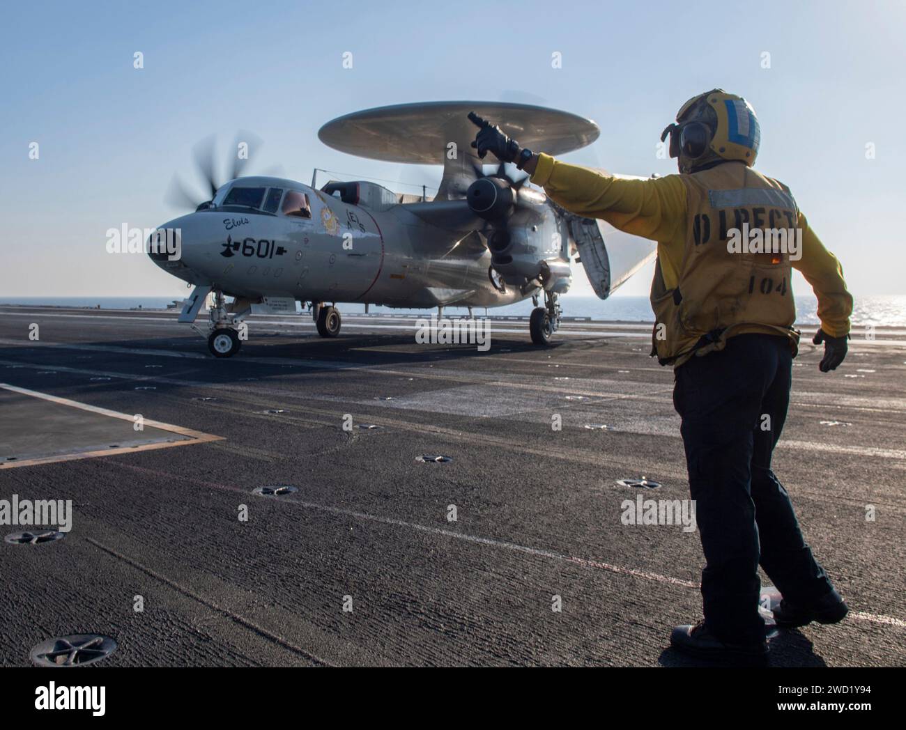 A Sailor conducts an E-2C Hawkeye on the flight deck of USS Nimitz ...
