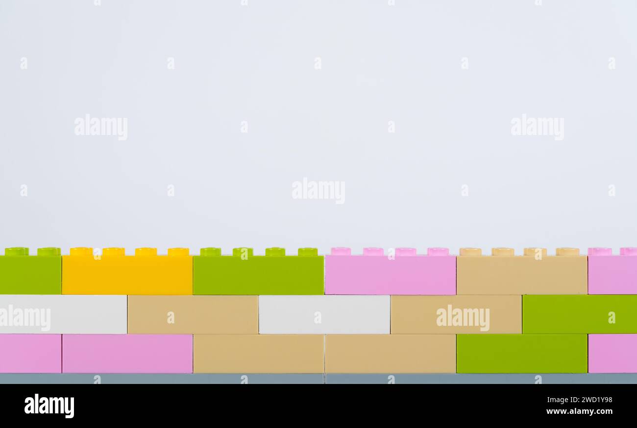 Colorful plastic bricks wall on white background Stock Photo - Alamy