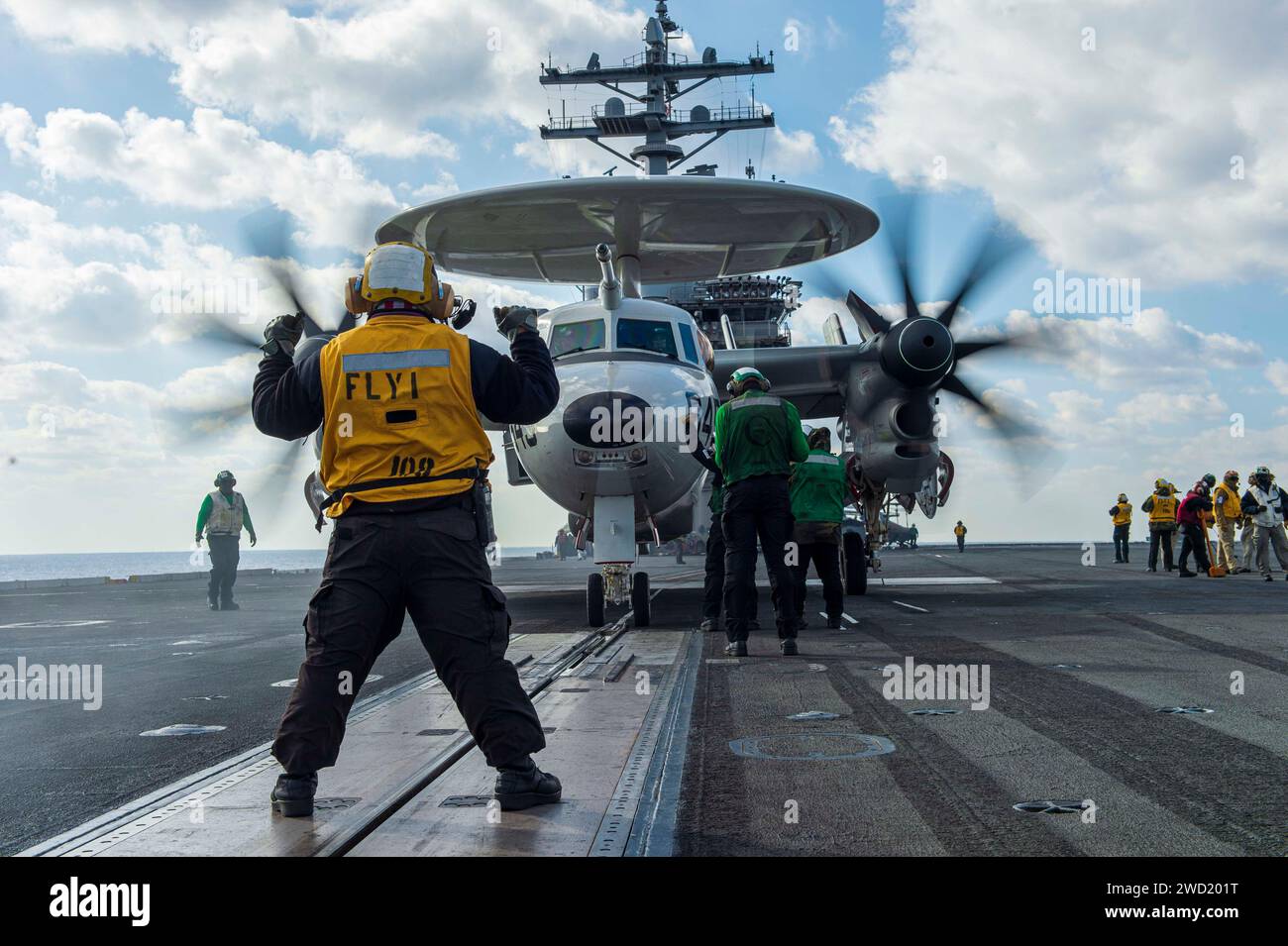 An E-2D Hawkeye taxis on the flight deck of the Nimitz-class aircraft ...