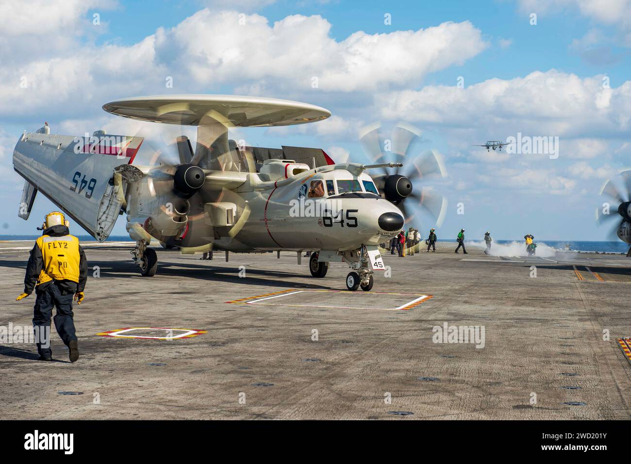 An E-2D Hawkeye taxis on the flight deck of the Nimitz-class aircraft ...
