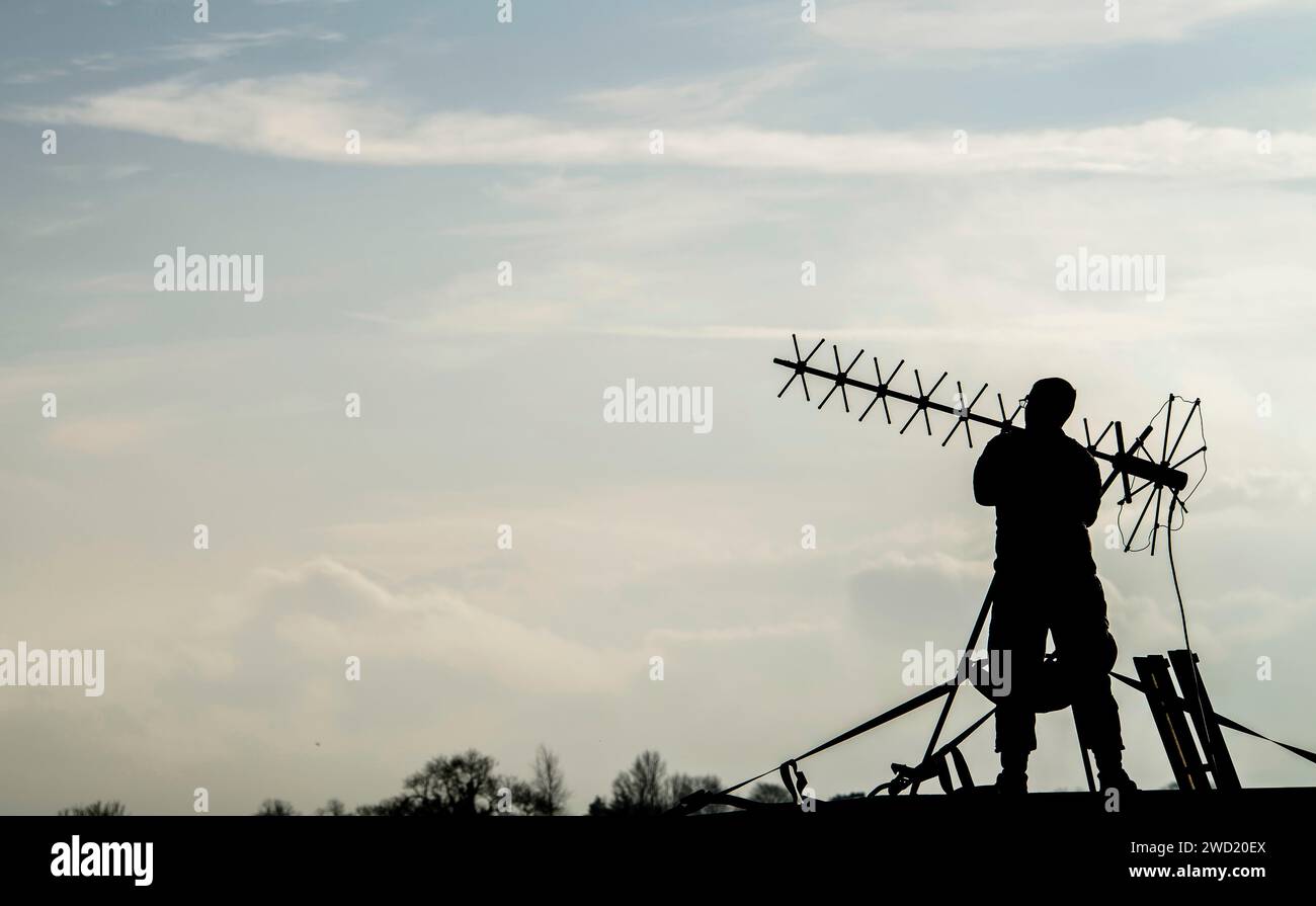 A U.S. Air Force radio frequency transport system apprentice, adjusts ...