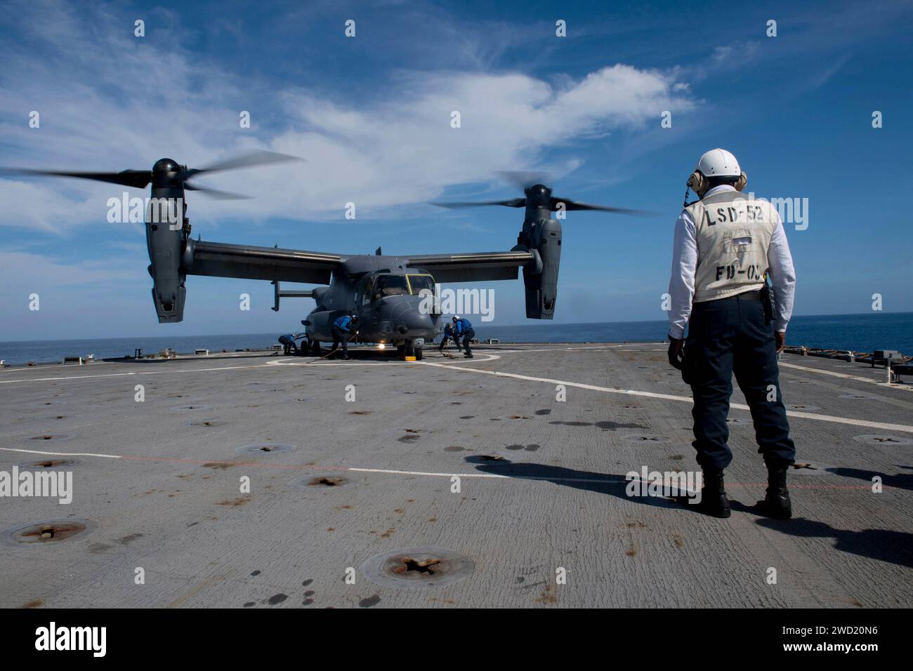 U.S. Sailors remove chocks and chains from a CV-22 Osprey aircraft ...
