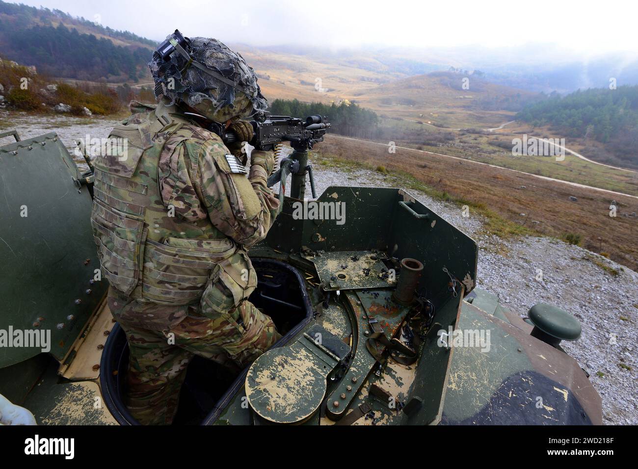 A U.S. Army Paratrooper engages targets with a M240B machine gun in ...