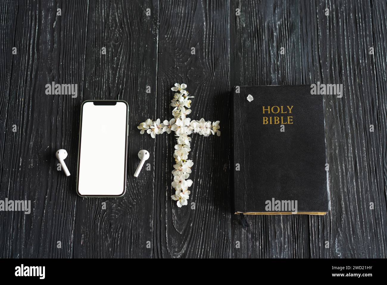 Spring flowers in the shape of a cross, a phone with headphones and ...