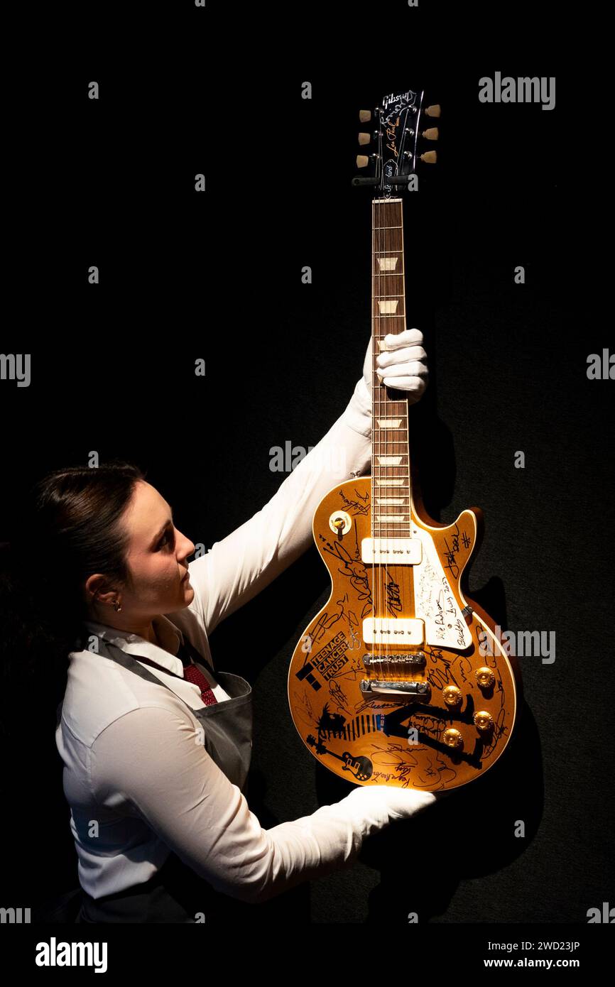 A Christie's art handler holds up Mark Knopfler's Les Paul Standard ...