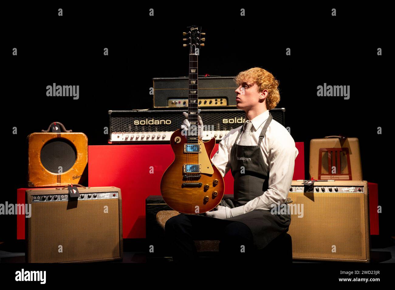 A Christie's art handler holds up a Gibson Les Paul guitar, which forms ...