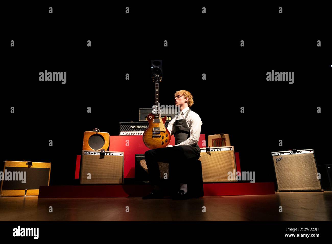 A Christie's art handler holds up a Gibson Les Paul guitar, which forms ...