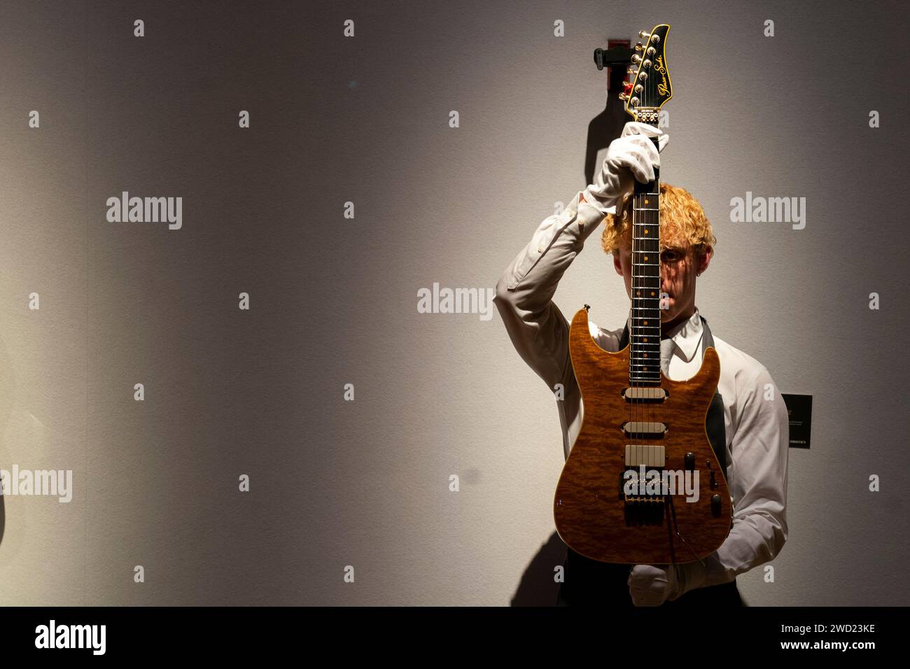 A Christie's art handler holds up Mark Knopfler's 1988 Pensa-Suhr MK-1 ...