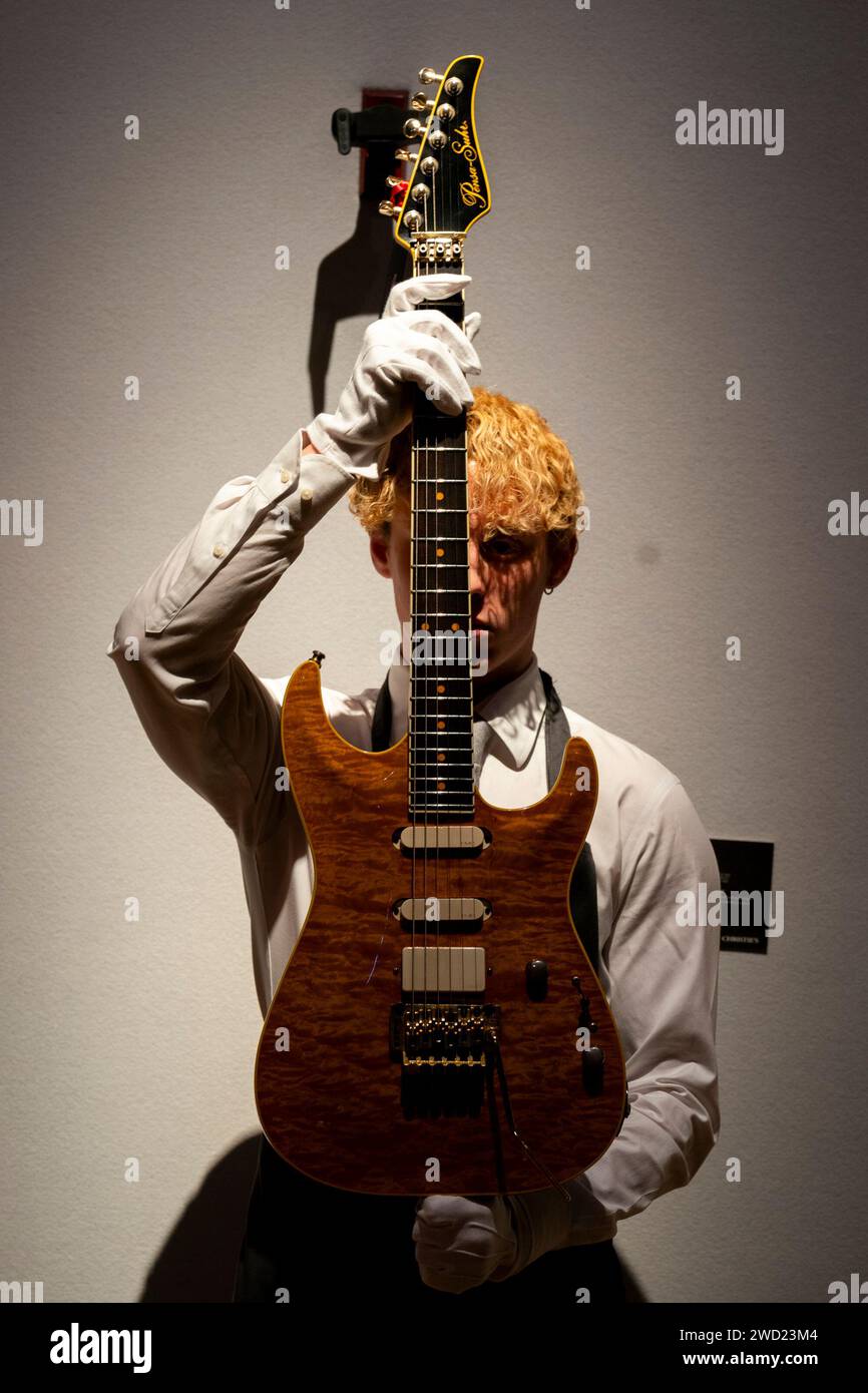 A Christie's art handler holds up Mark Knopfler's 1988 Pensa-Suhr MK-1 ...