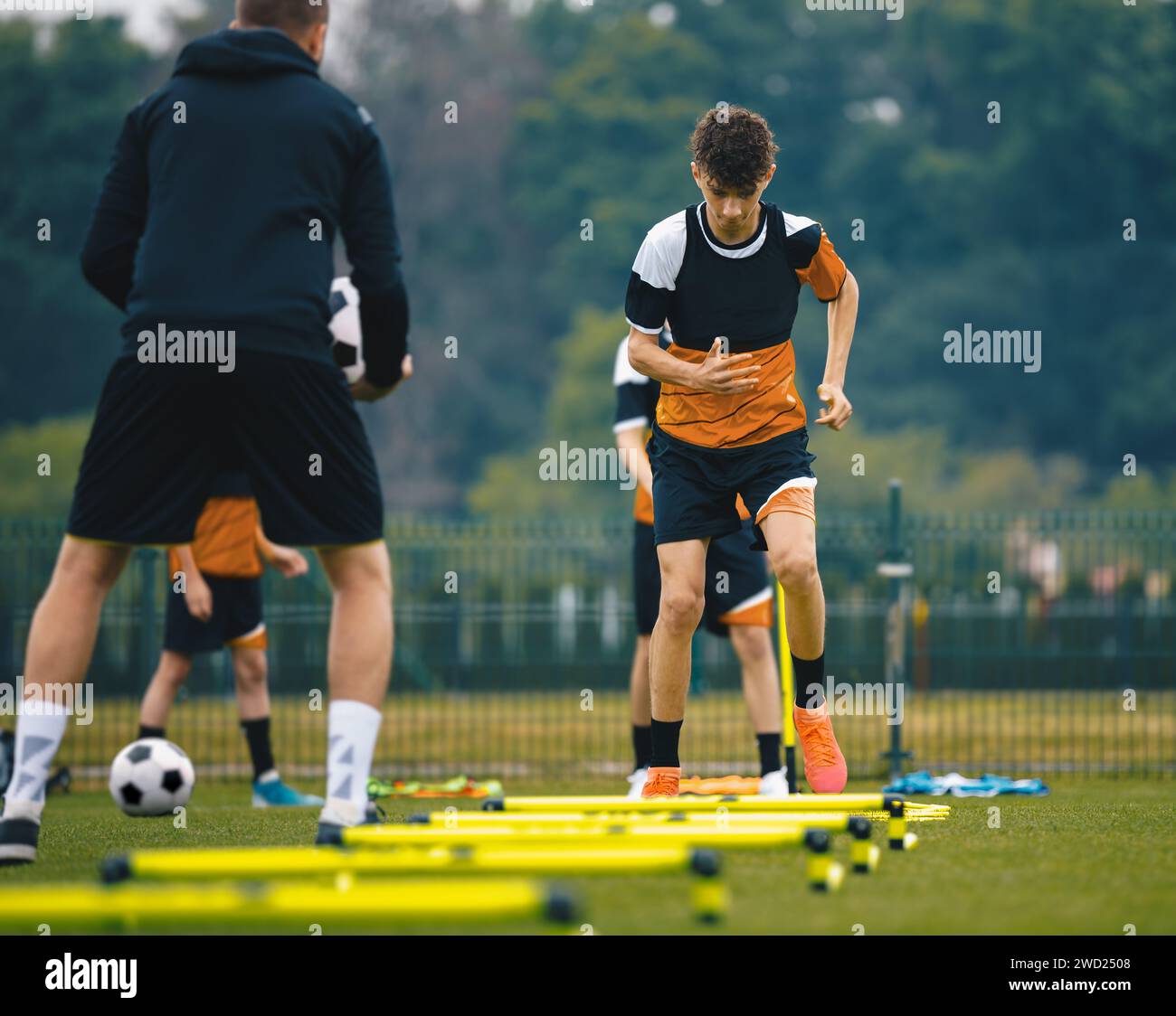 Boys' Soccer Practice Camp. Teenage boys in football training with a ...
