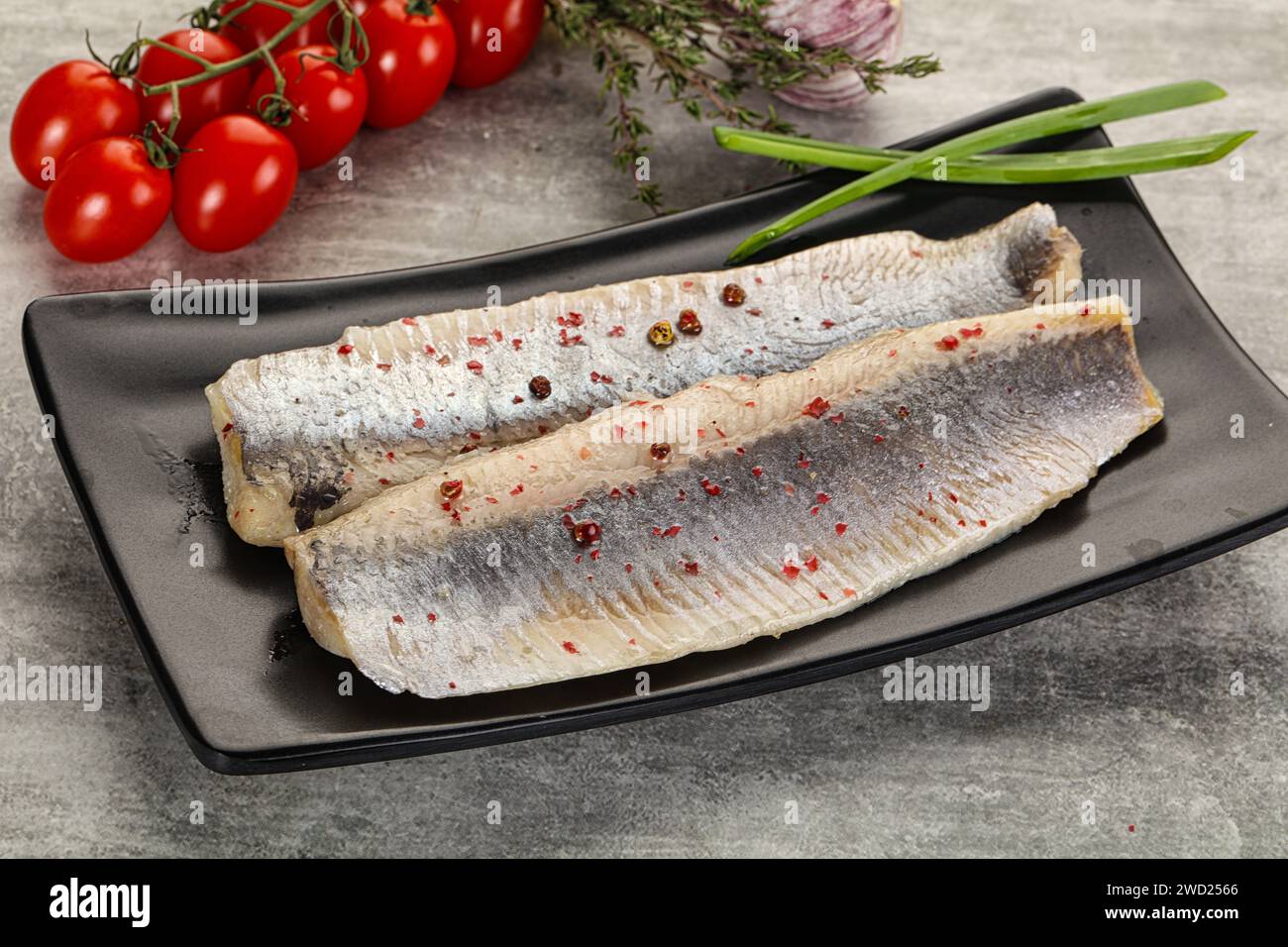 Marinated salted herring fillet with green onion Stock Photo - Alamy