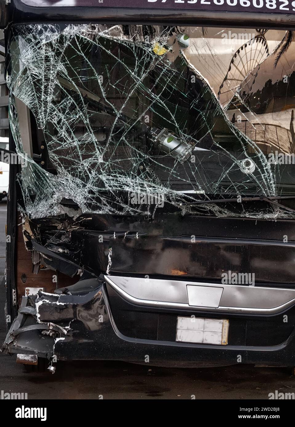 A road accident. The large windshield of the bus was shattered but not ...