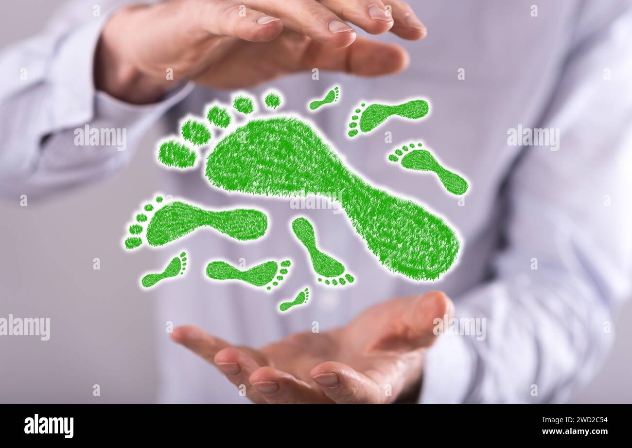 Carbon footprint concept between hands of a man in background Stock ...