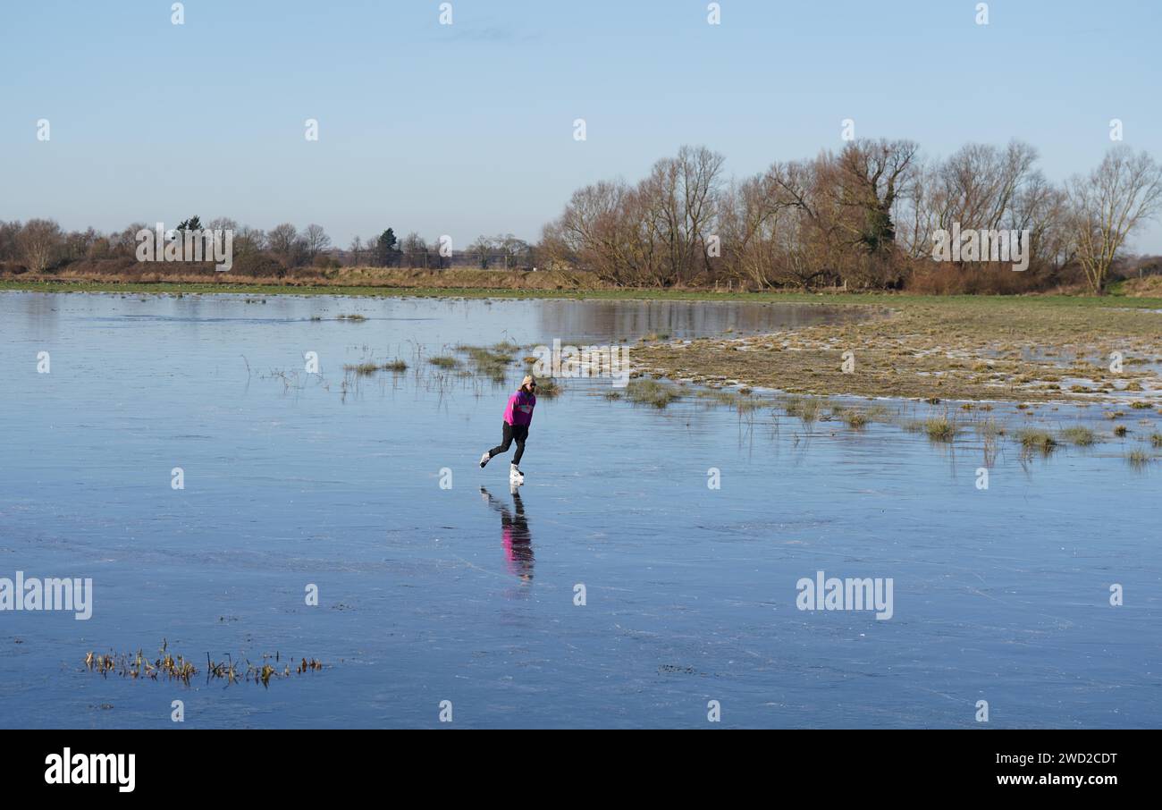 Fen skaters on a frozen flooded field in Upware, Cambridgeshire. The UK ...