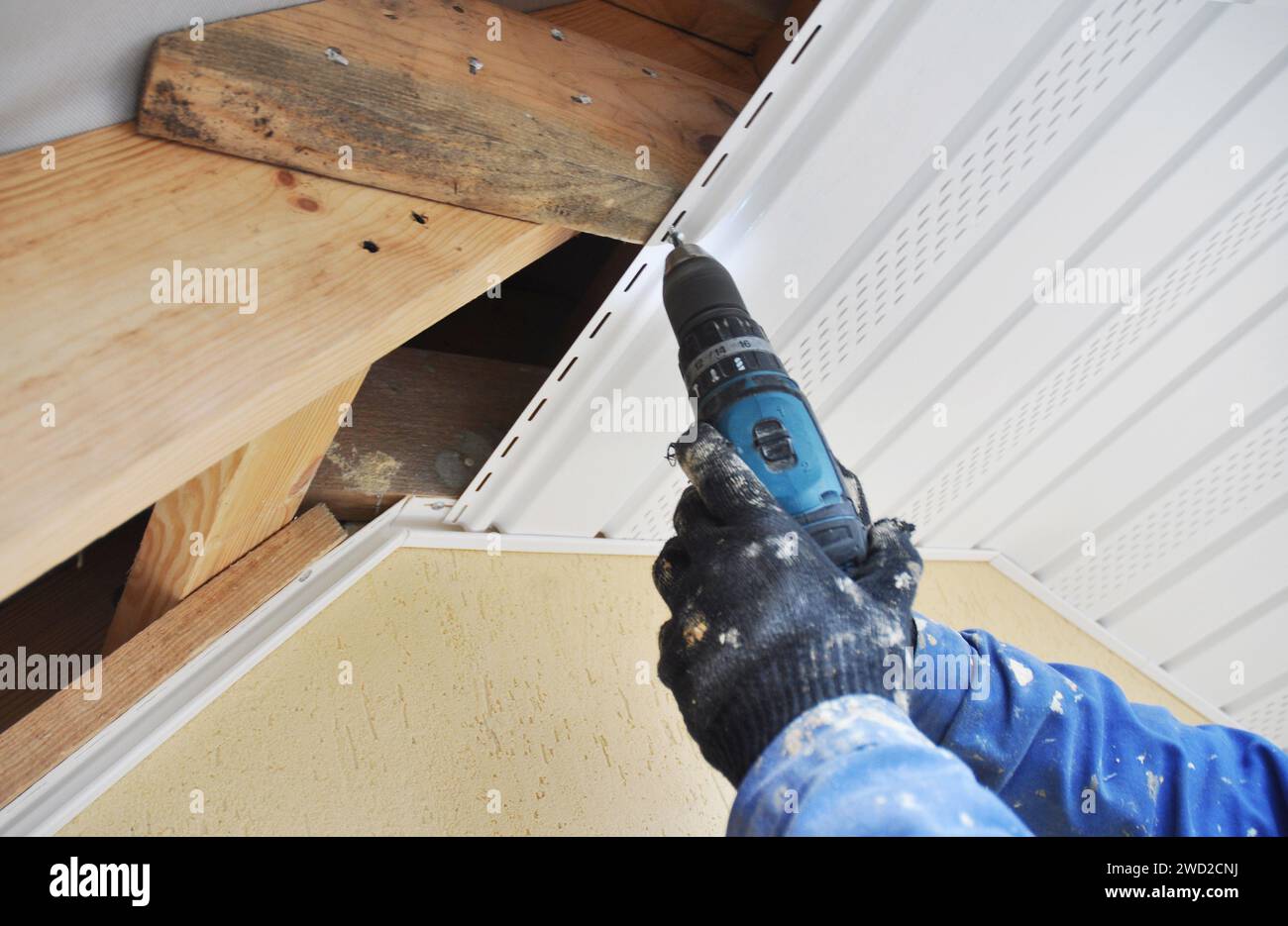 Roofer contractor install soffit boards on rooftop with screw gun Stock ...