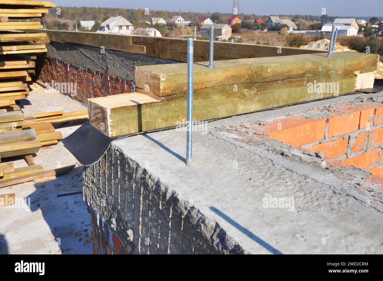 Beginning the roofing construction of the house by mounting the trusses ...