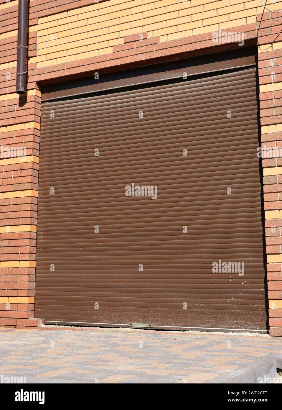 A close-up on a rolling automatic garage door of a large car garage ...