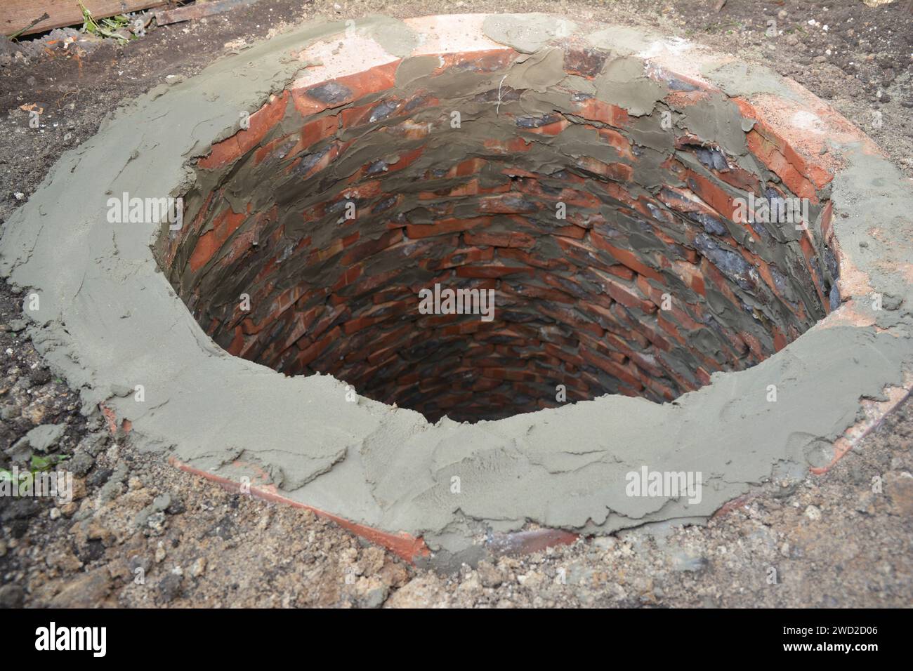 Installing brick septic tank. Sewer brick tank hole installation on ...