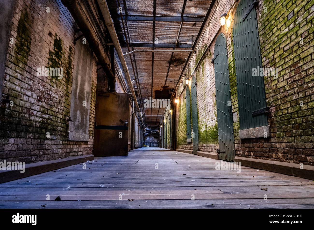 A corridor in an old, abandoned jail with brick walls Stock Photo - Alamy
