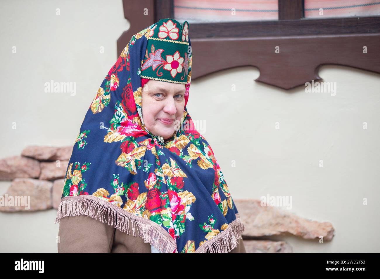 An elderly Russian woman in a traditional headdress, kokoshnik, poses ...
