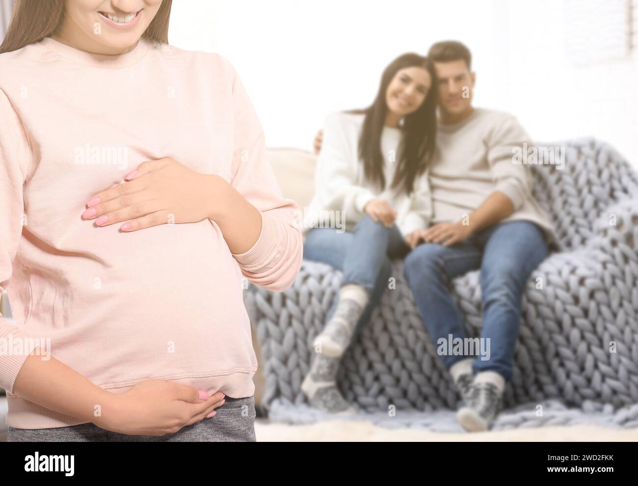 Surrogate mother and intended parents in room Stock Photo - Alamy