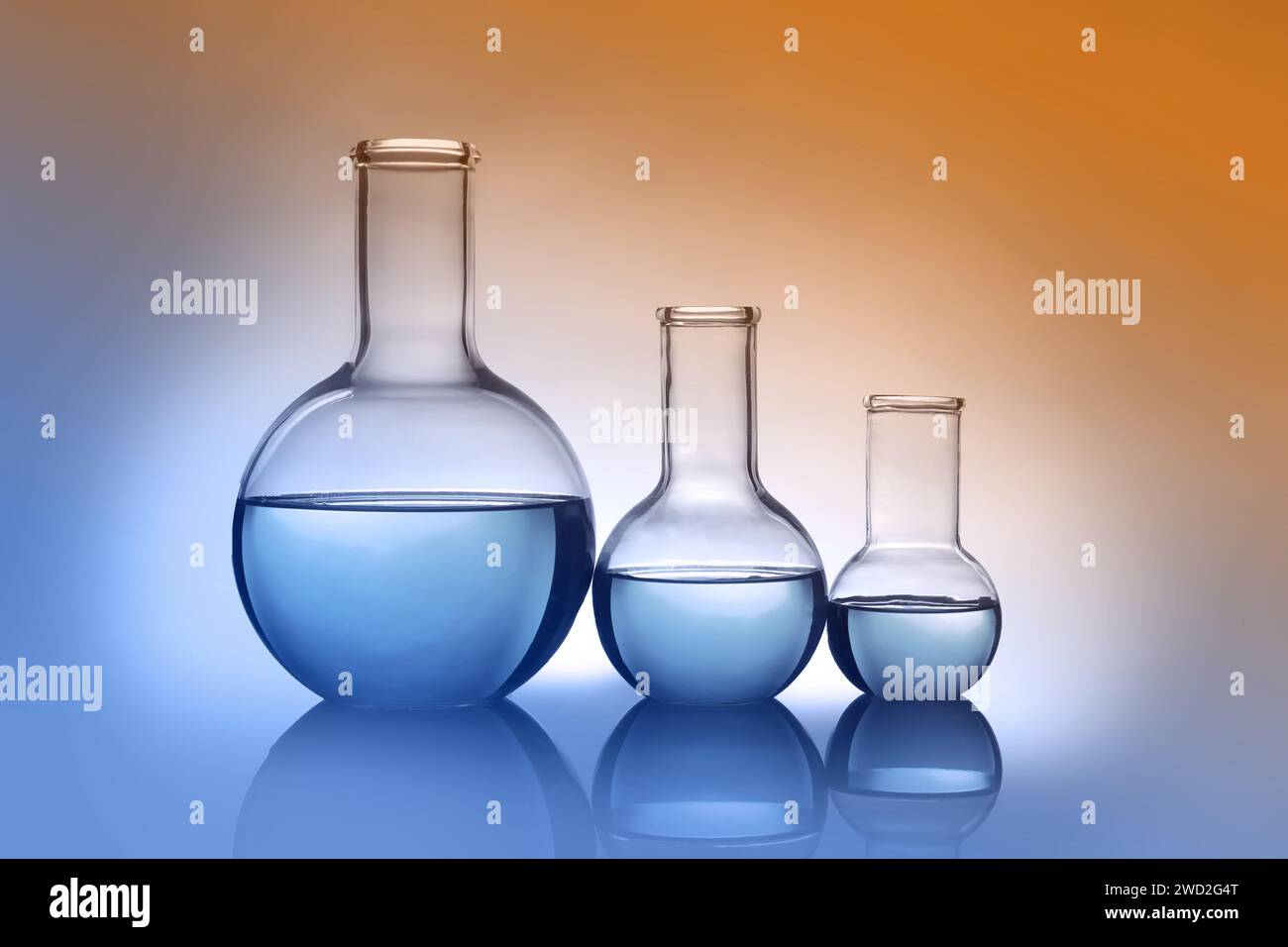 Flasks with liquid on table. Color toned Stock Photo - Alamy