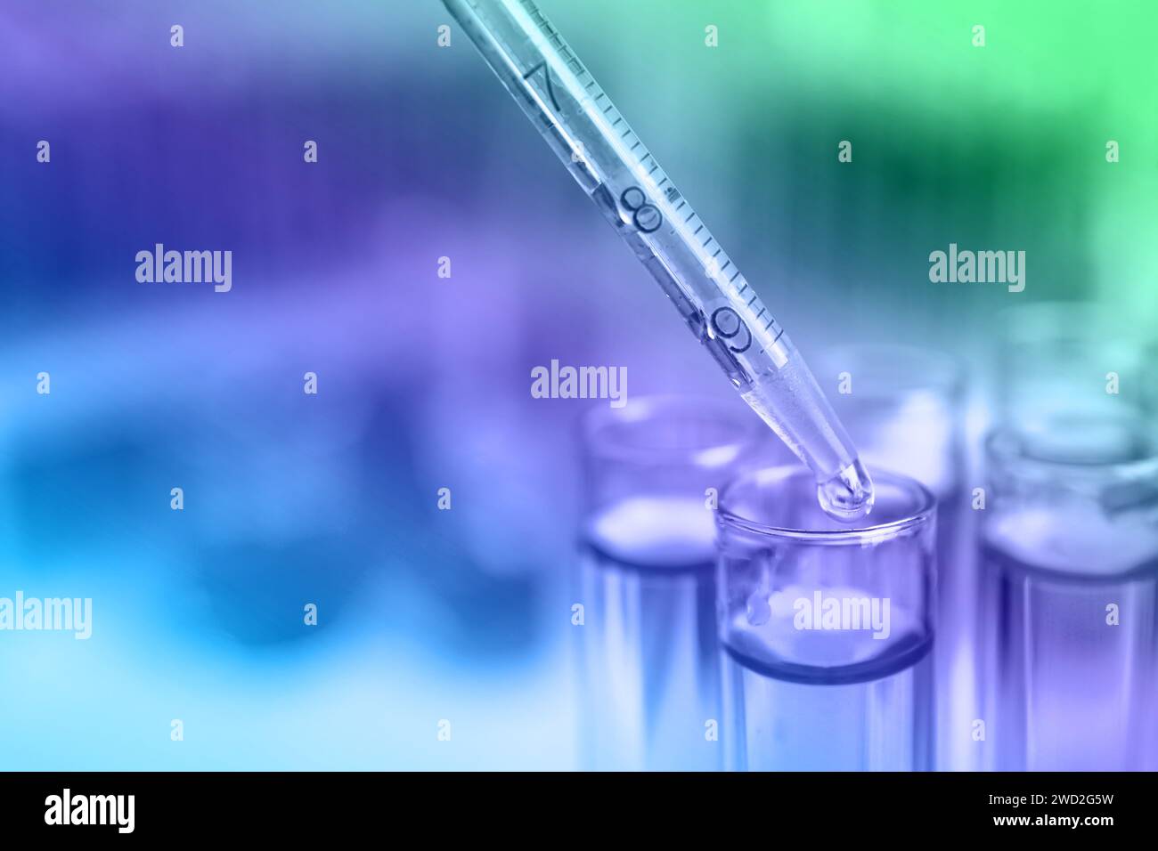 Dripping reagent into test tube with sample, closeup. Color toned Stock ...