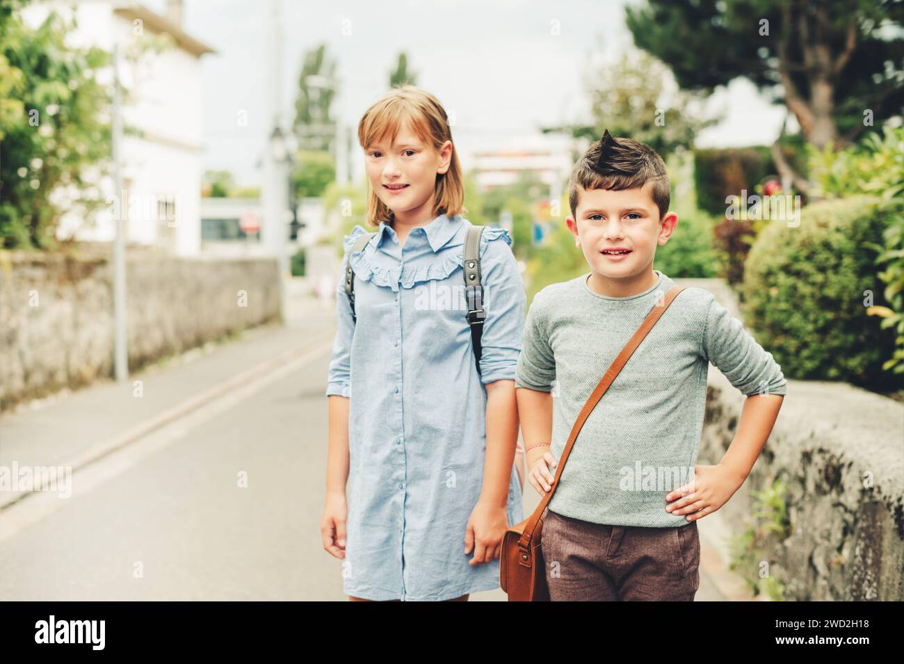 Cute kids with backpacks walking back to school Stock Photo - Alamy