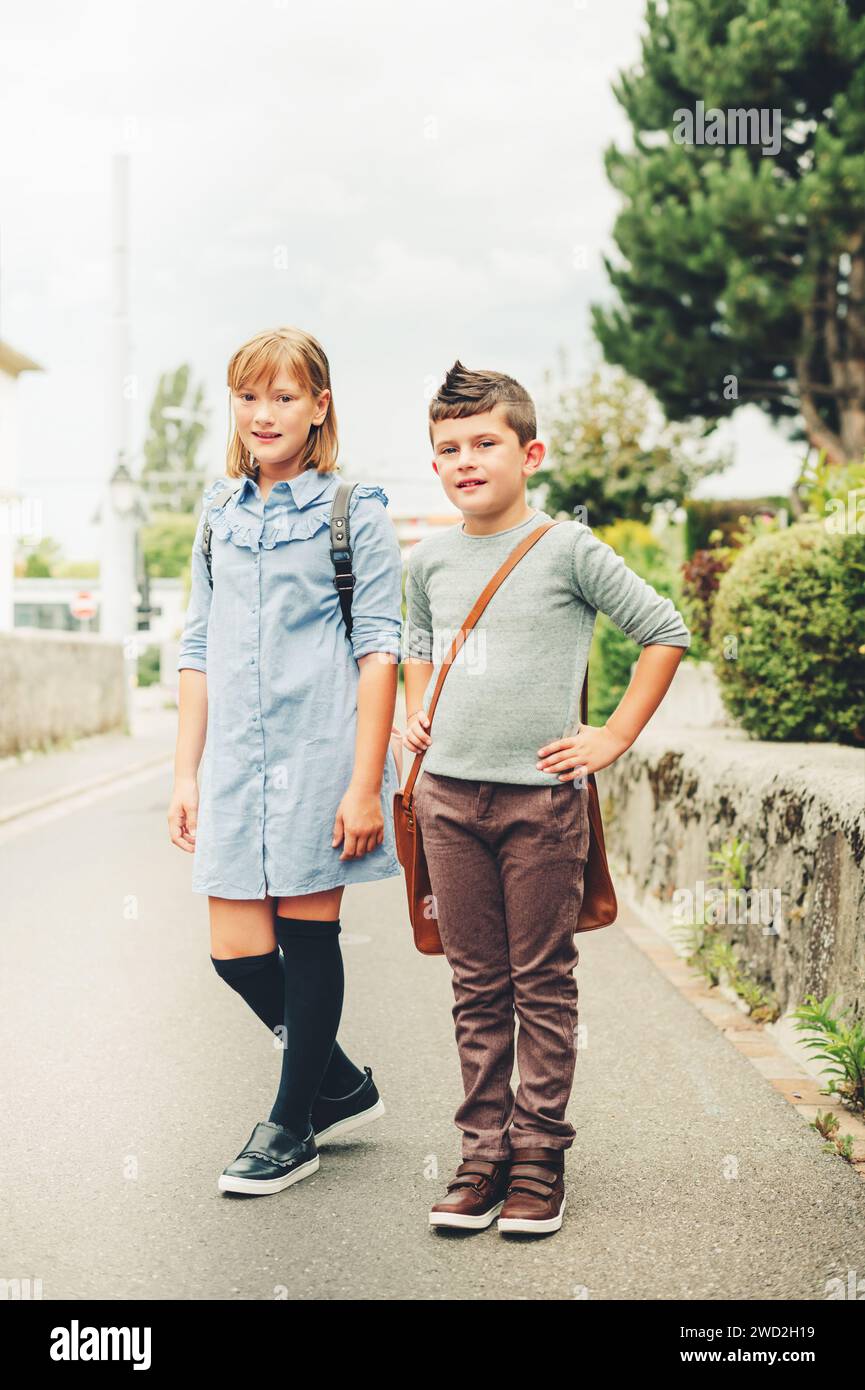 Cute kids with backpacks walking back to school Stock Photo - Alamy