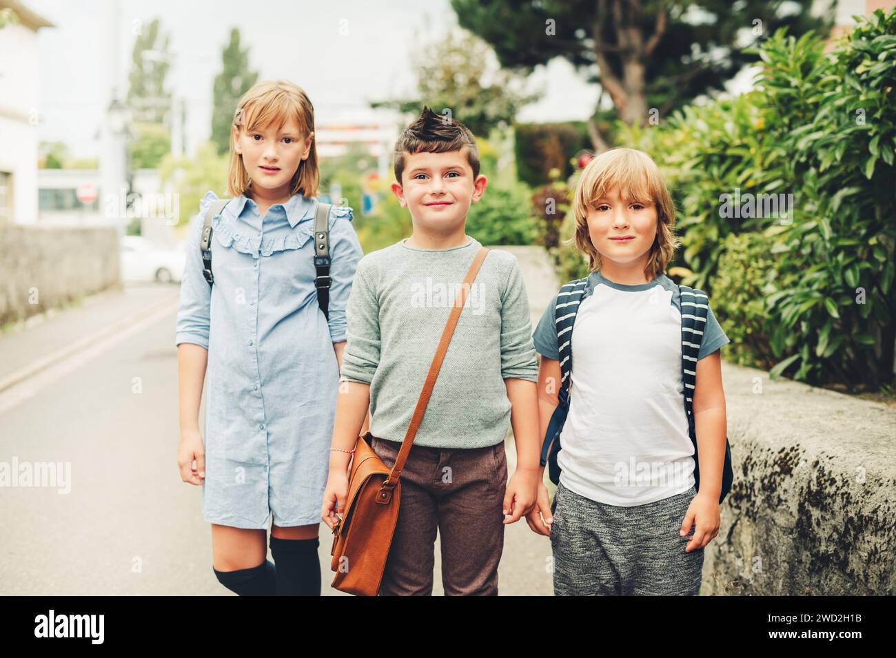 Cute kids with backpacks walking back to school Stock Photo - Alamy