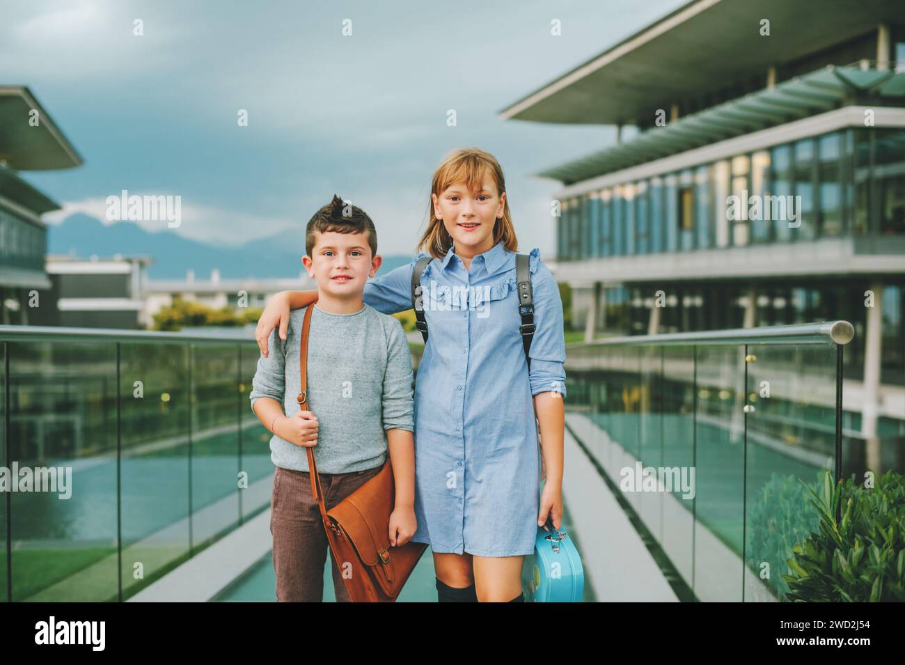 Cute kids with backpacks walking back to school Stock Photo - Alamy