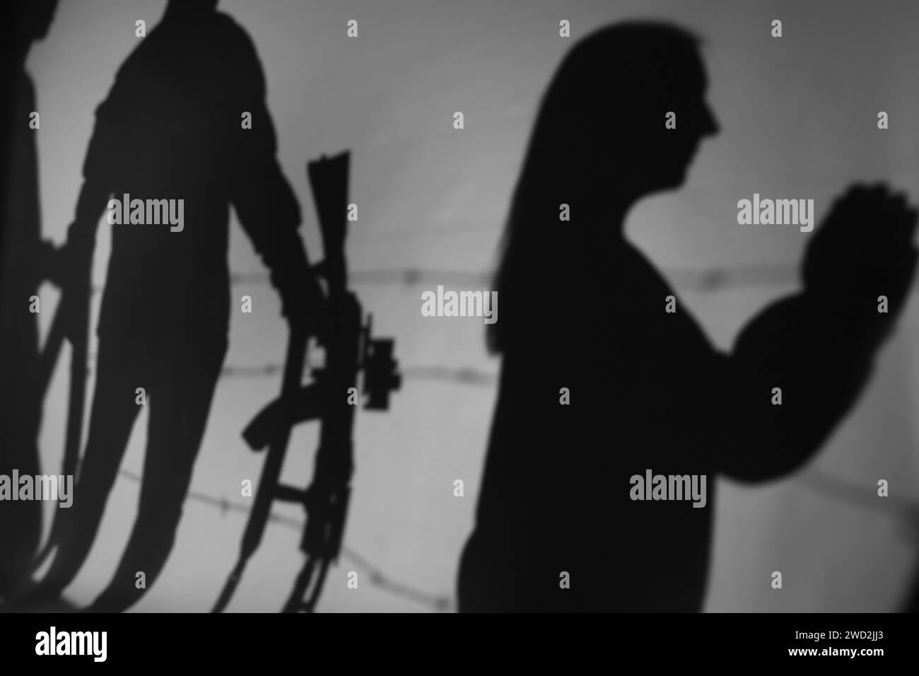Shadow of Jewish woman and armed man on grey background. International ...