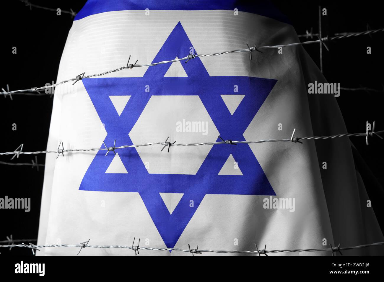 Jewish woman with flag of Israel behind barbed wire on black background ...