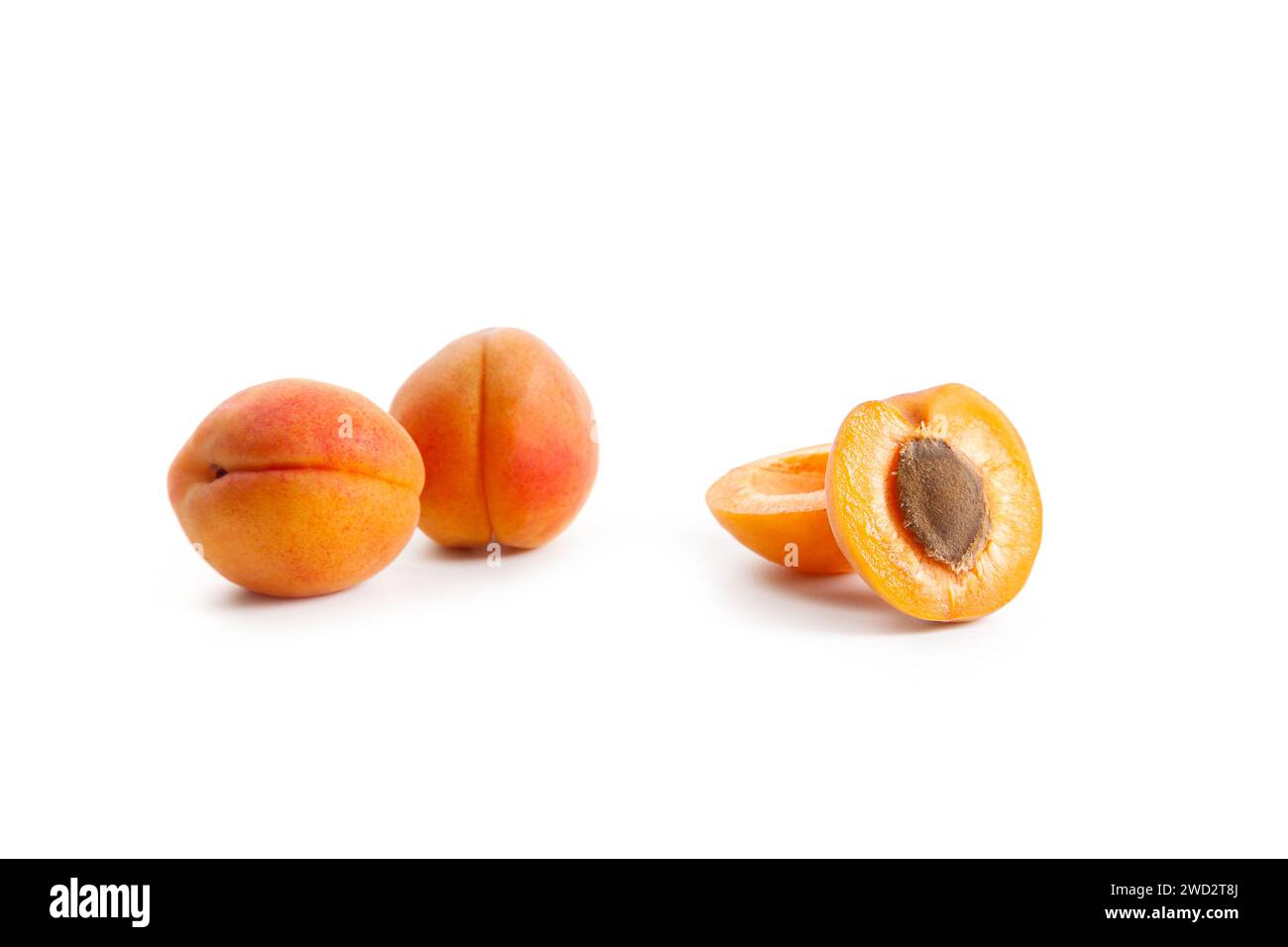 Two whole and half apricot fruits isolated on white background Stock ...