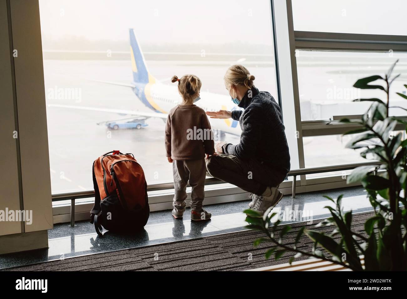 Man with girl ready to fly by airplane and the airport. Father and ...