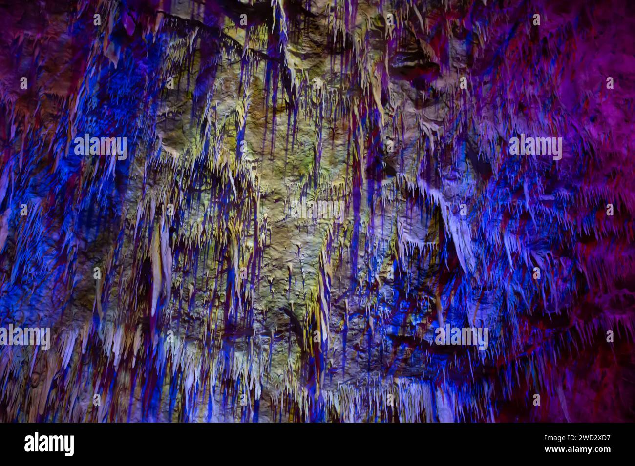 Karst cave, amazing view of stalactites and stalagnites in colorful ...