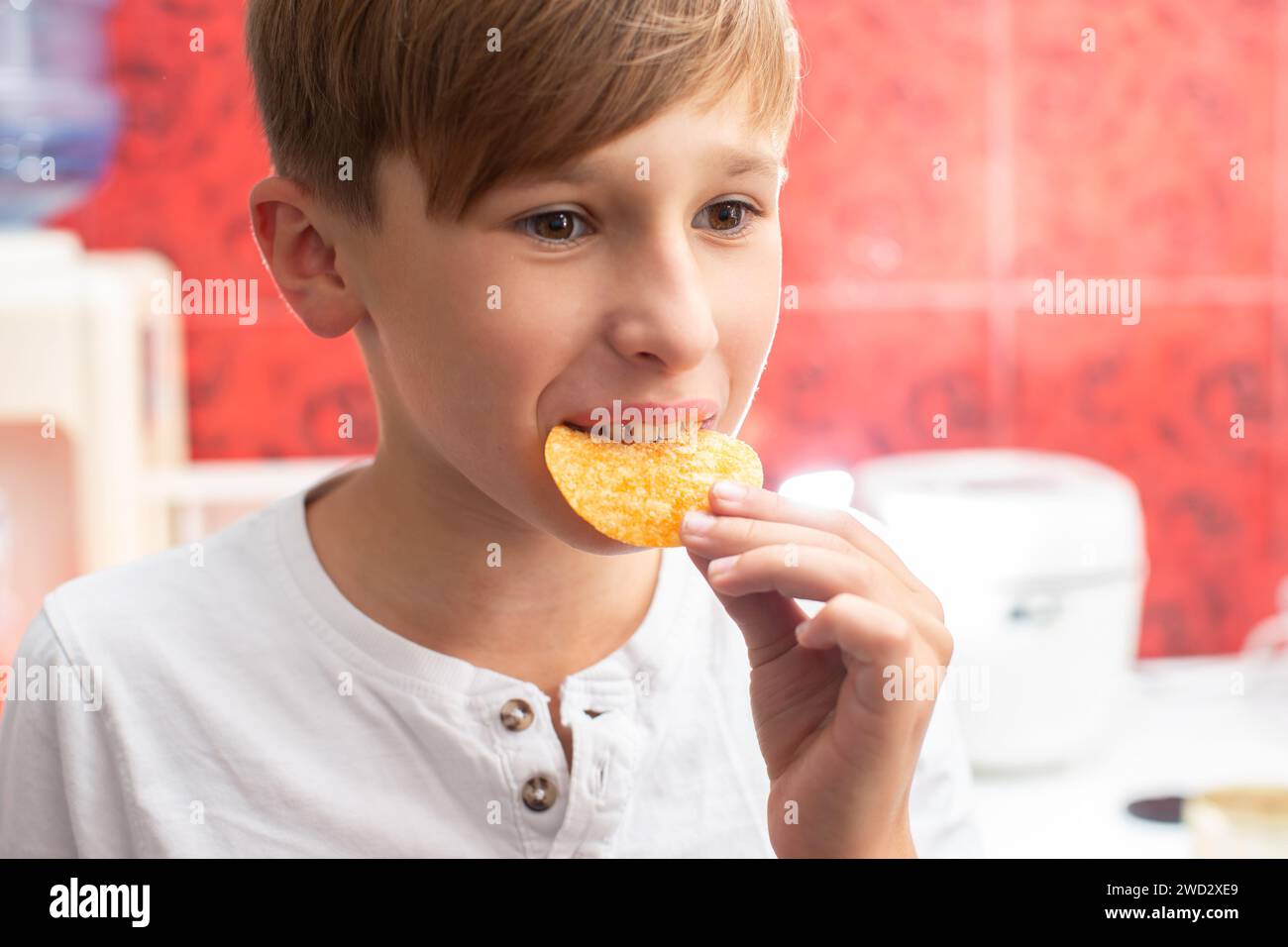 Fat child eating chips hi-res stock photography and images - Alamy