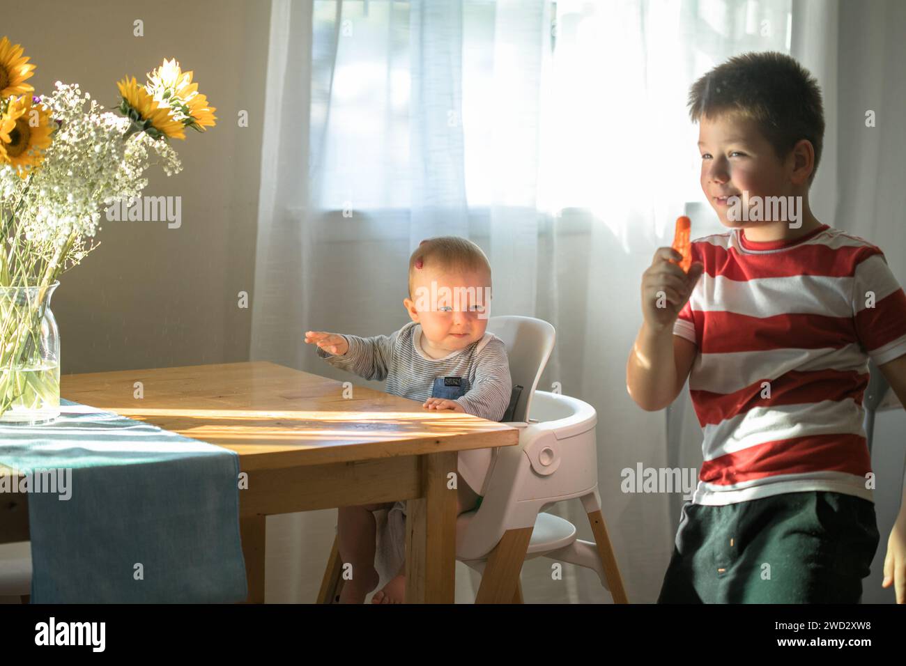 Older brother play with his baby boy. Two siblings. Beautiful lovely ...