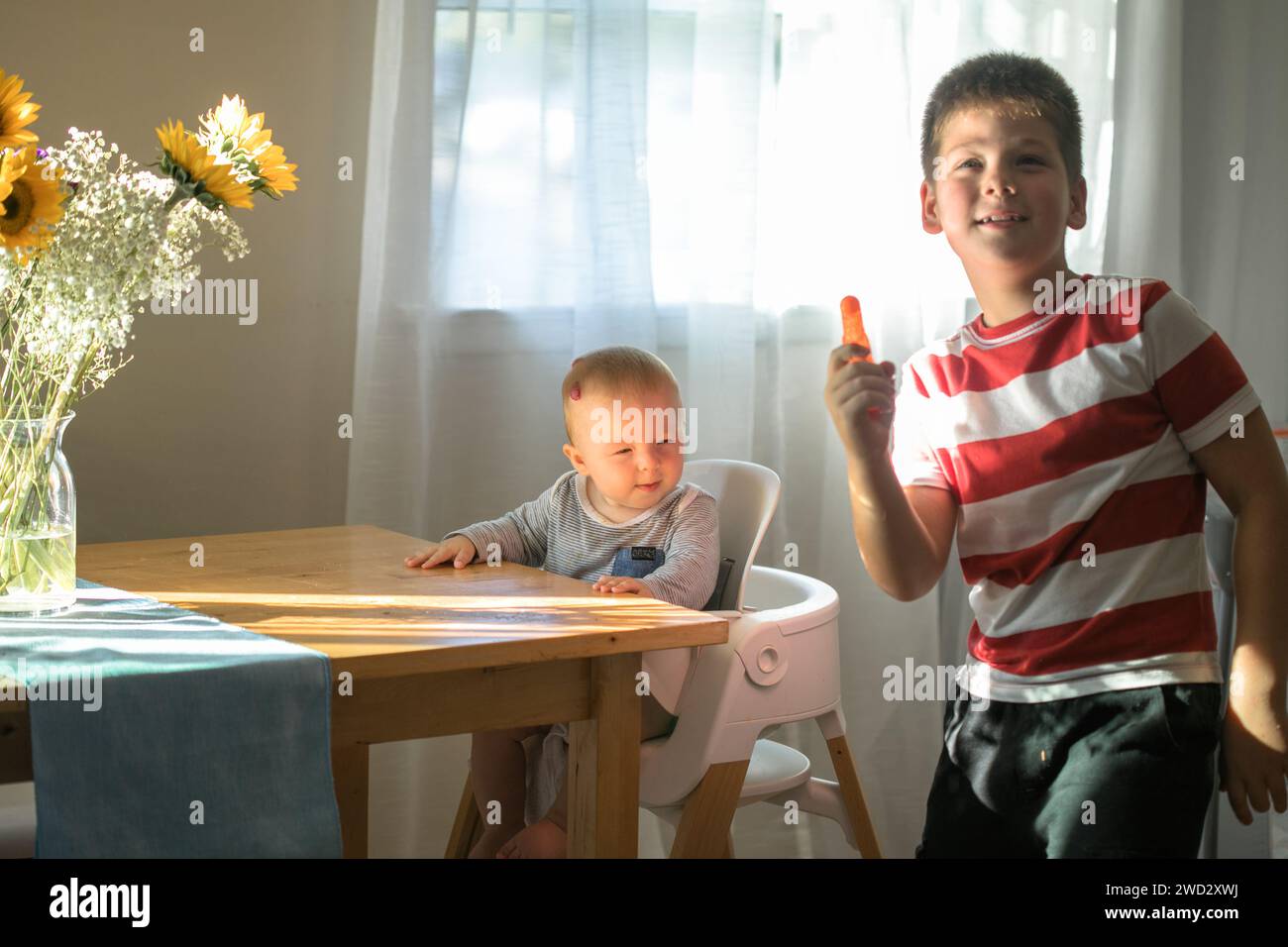 Older brother play with his baby boy. Two siblings. Beautiful lovely ...