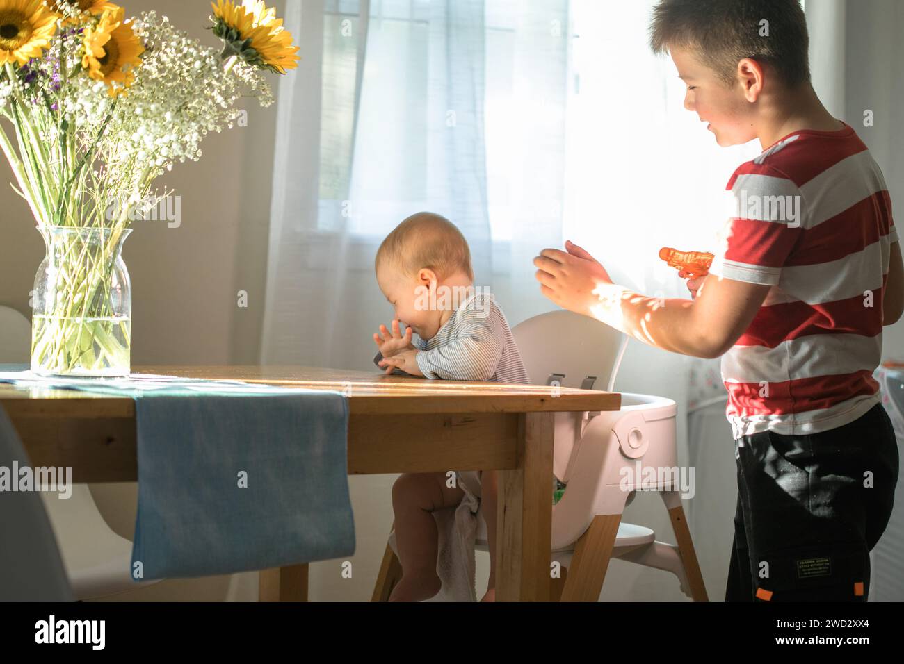 Older brother play with his baby boy. Two siblings. Beautiful lovely ...