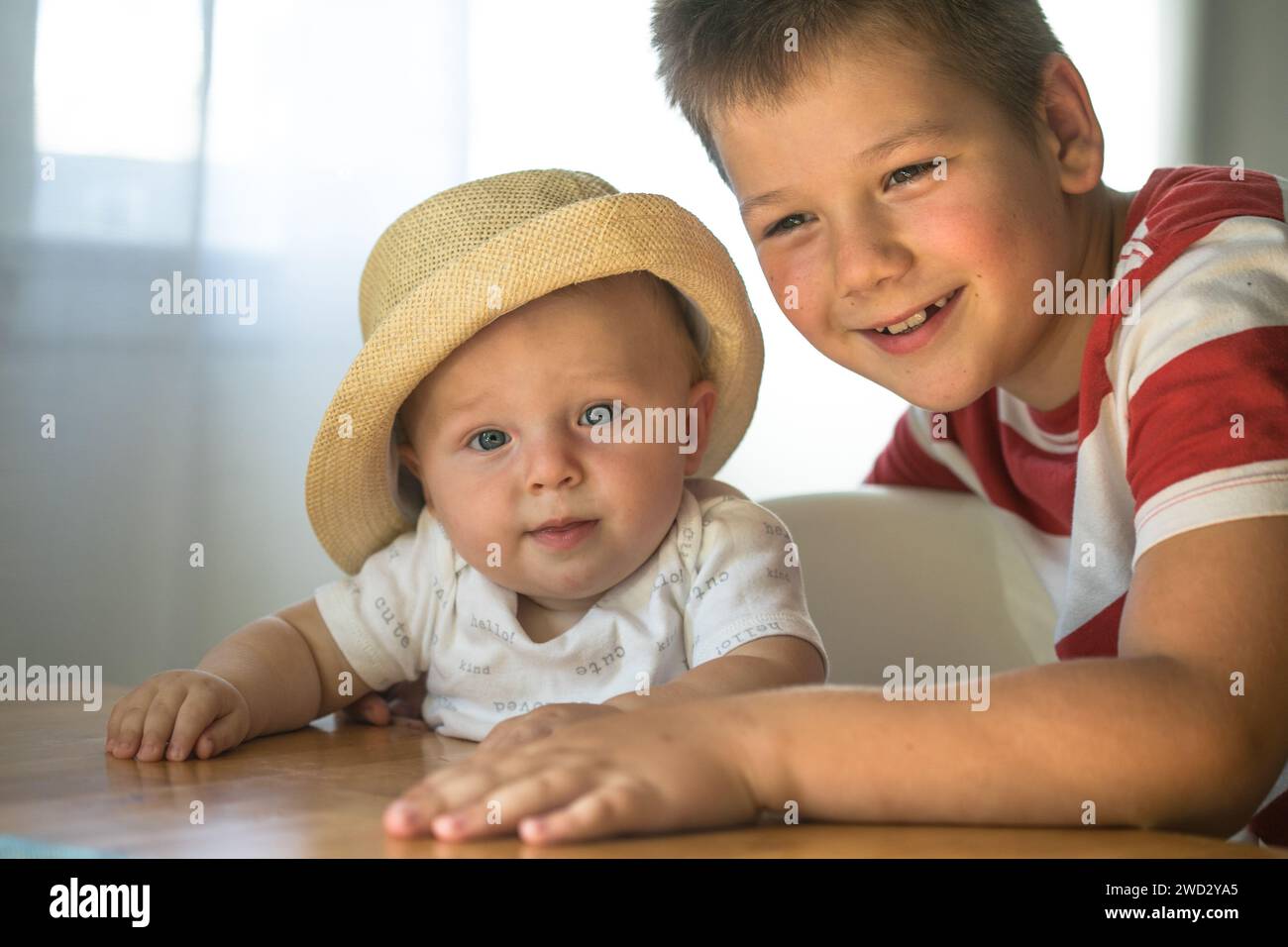 Brother boys hugs younger, taking care of sibling. concept siblings and ...