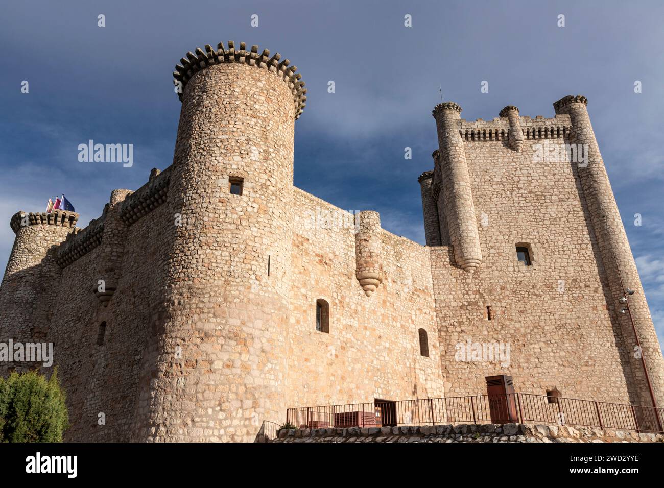 historic stone castle with tall towers and crenellated parapets, under ...