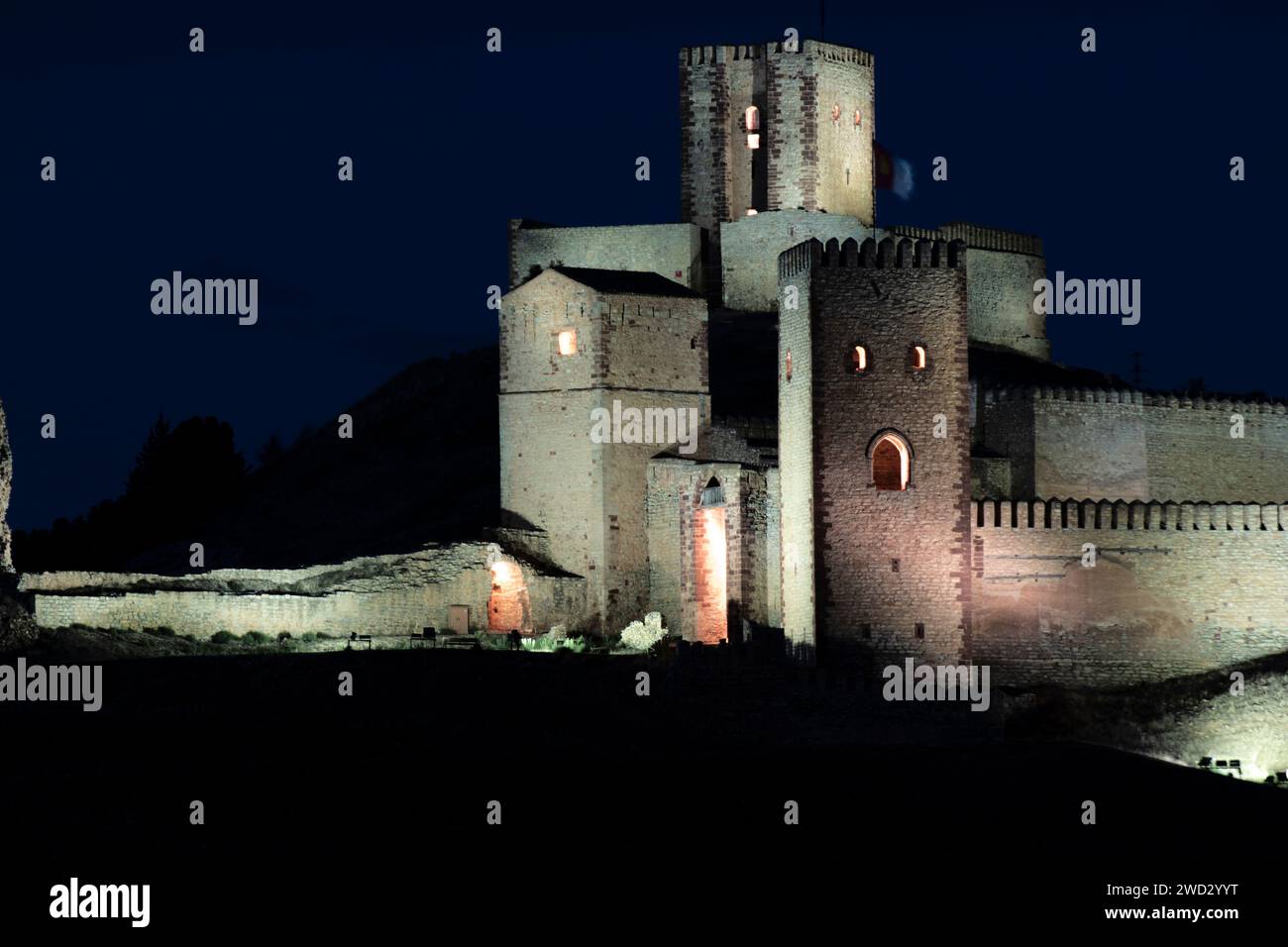 medieval castle illuminated at night, highlighting its stone walls and ...