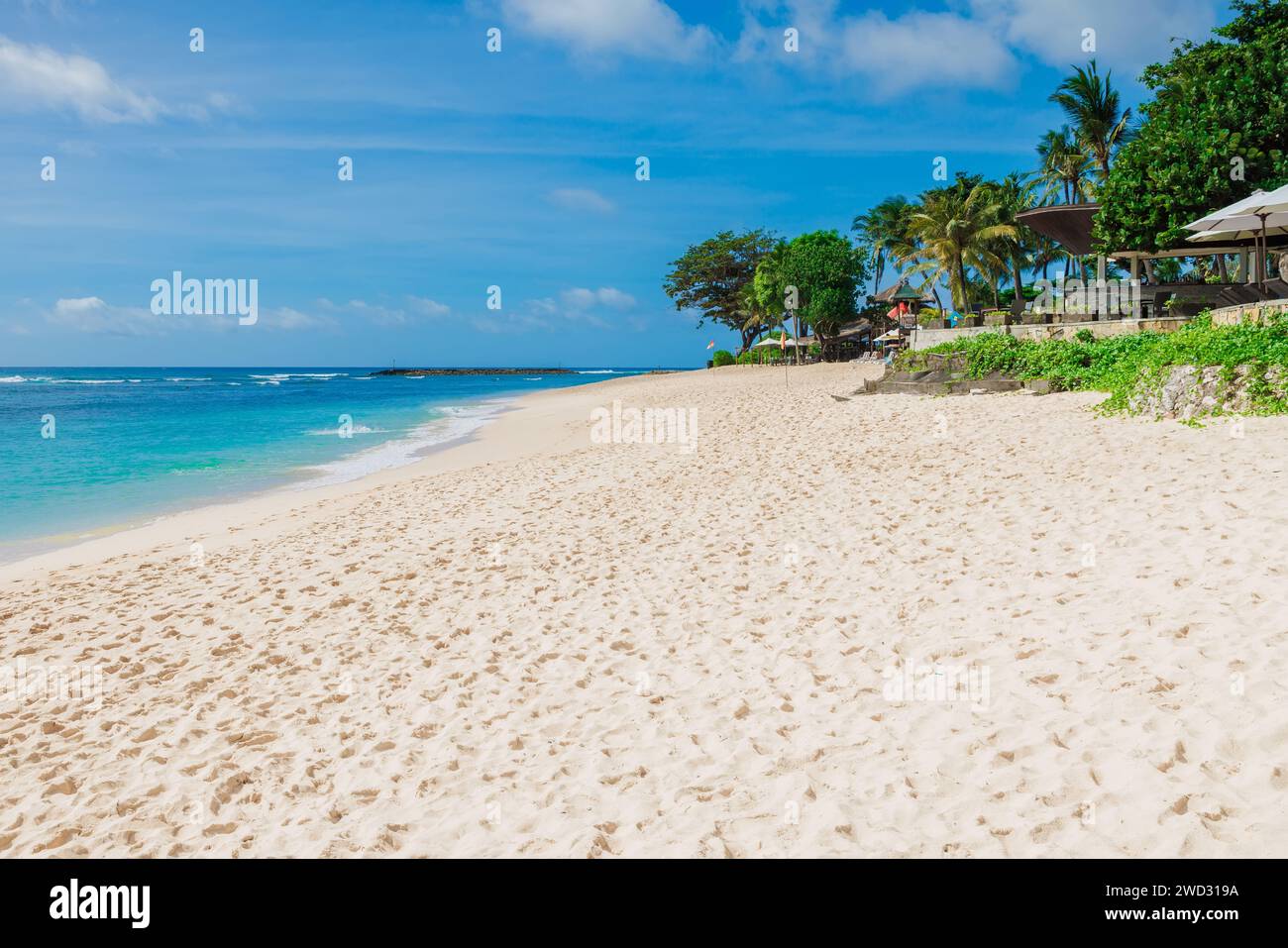 Best holiday beach in Bali. Scenic coastline with palms Stock Photo - Alamy