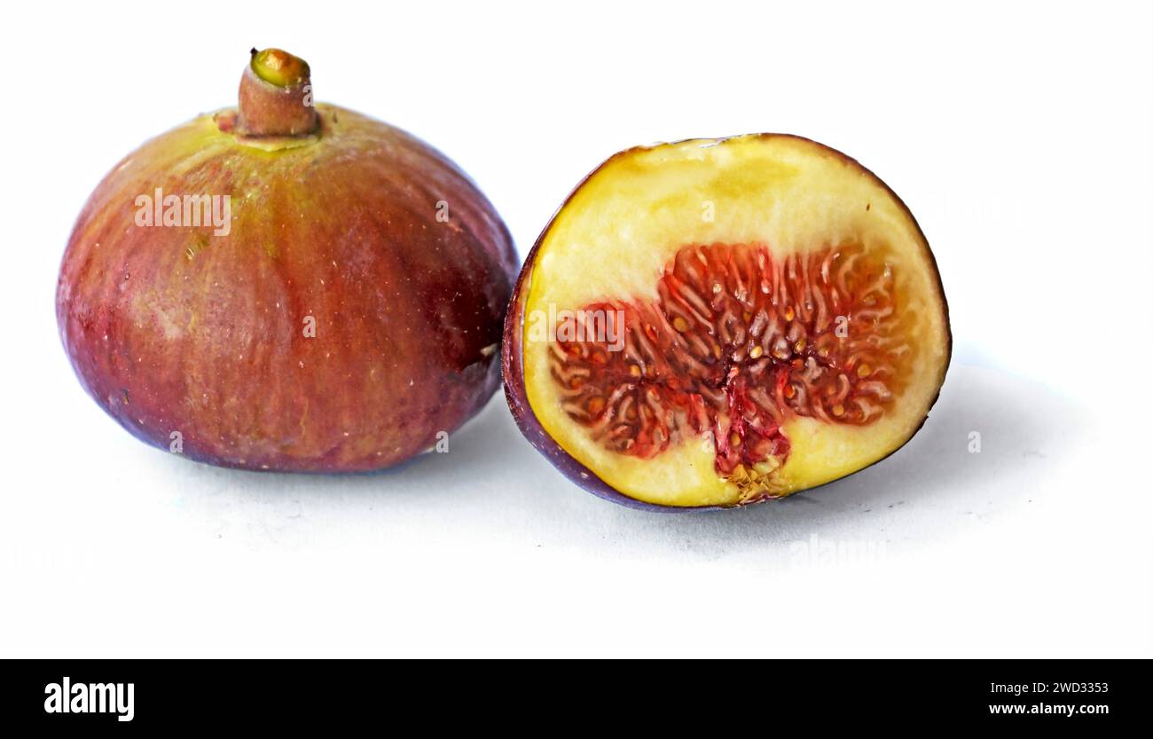 Fig and section isolated on white background Stock Photo - Alamy