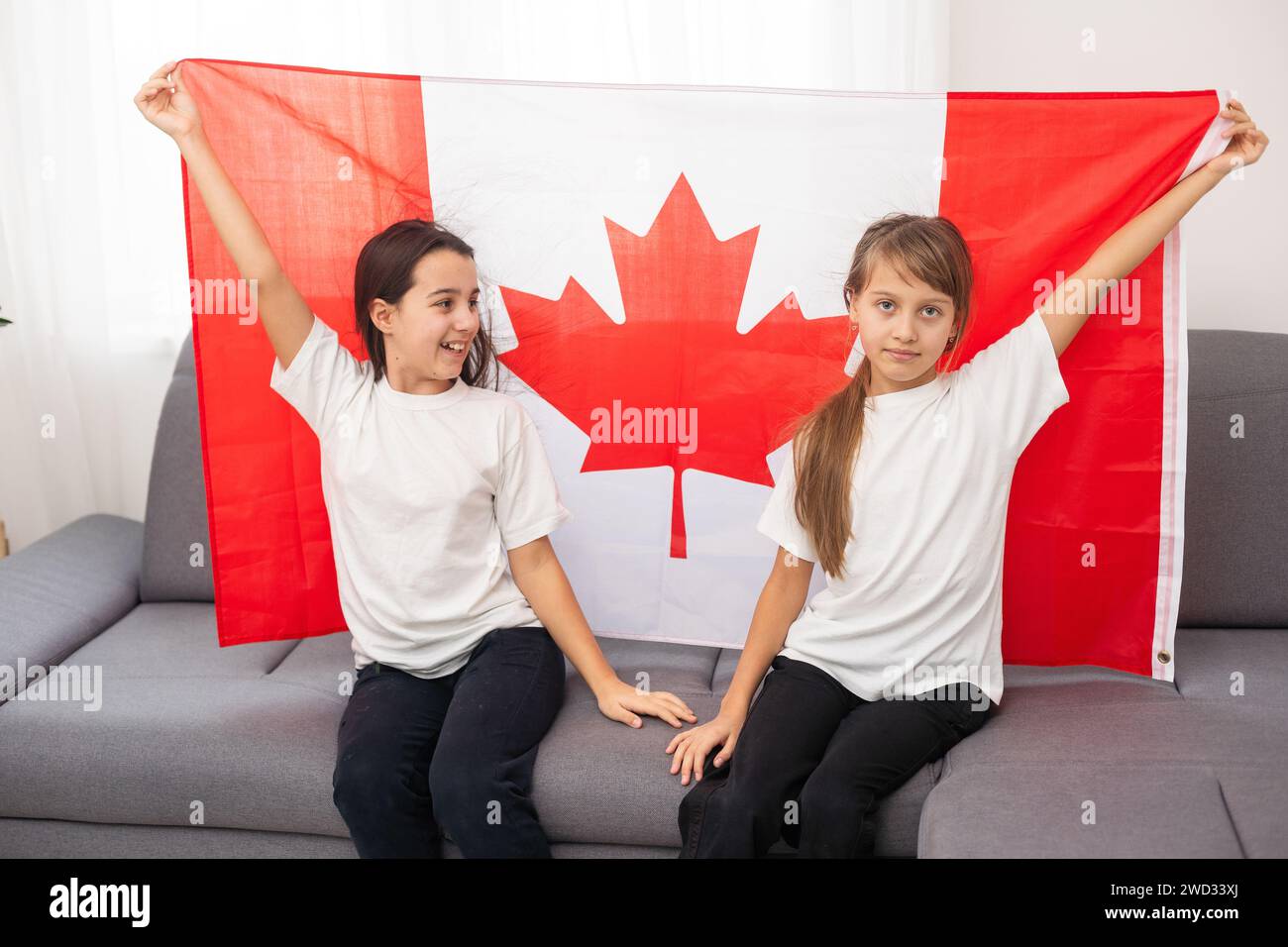 Happy Canada Day Celebration. Two girls with big Canada flag in their ...