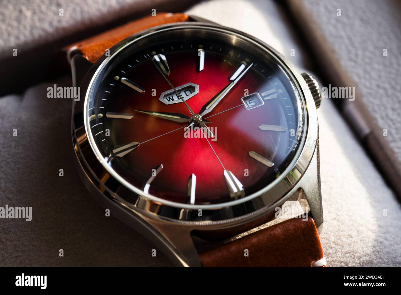 Mechanical automatic watch with red clock face, macro photo with ...