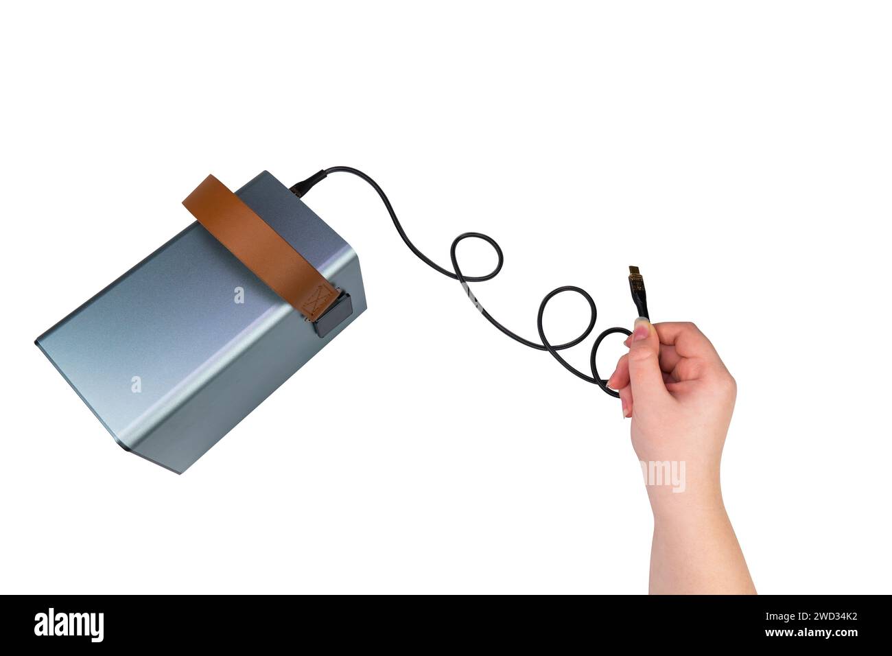 USB cable in hand, connected to a large power supply (charging station ...