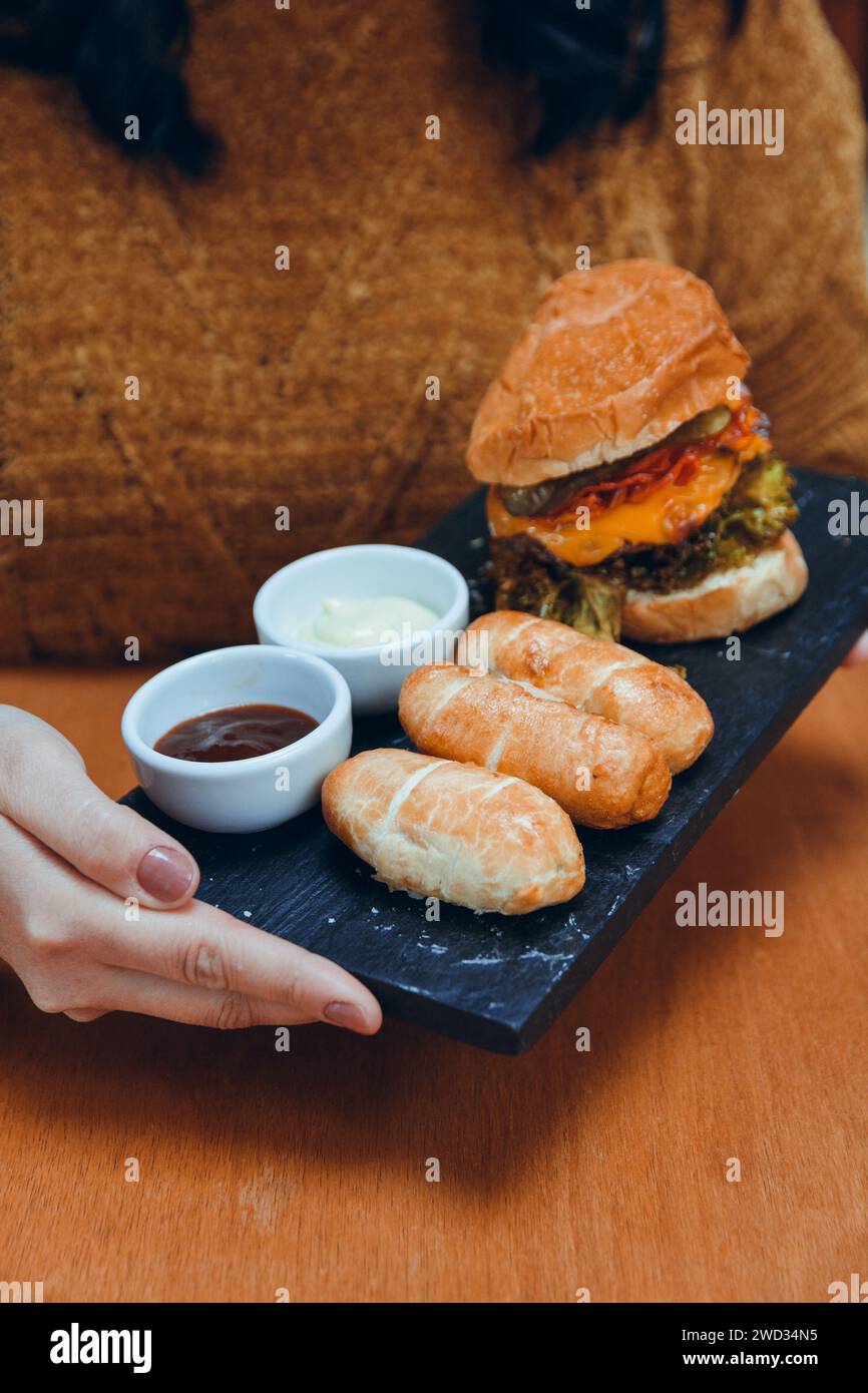 Vertical image of unrecognizable Caucasian woman holding plate of food ...