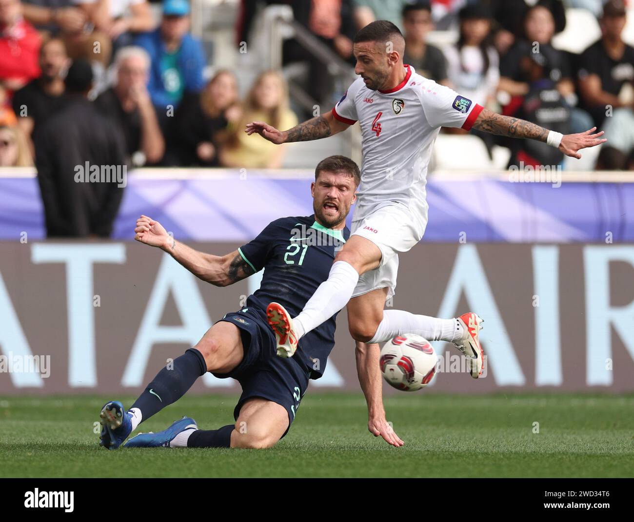 Doha, Qatar. 18th Jan, 2024. Syria's Ezequiel Ham (R) vies with ...